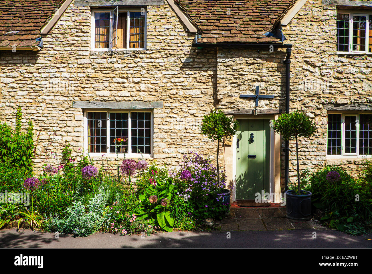 A pretty stone cottage in the Cotswold village of Castle Combe in ...