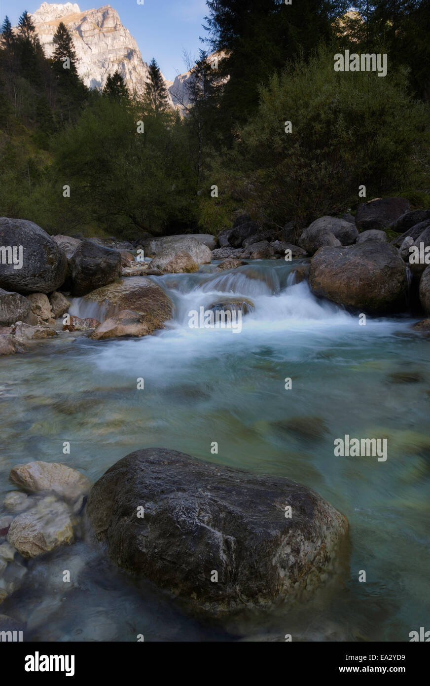 Alpine torrent with a mountain in the background Stock Photo - Alamy