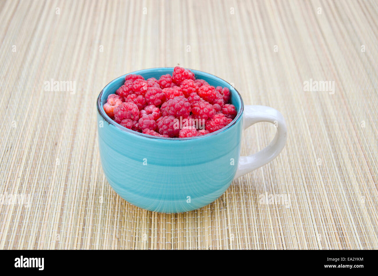 fresh summer time raspberry fruits in blue ceramic cup Stock Photo - Alamy
