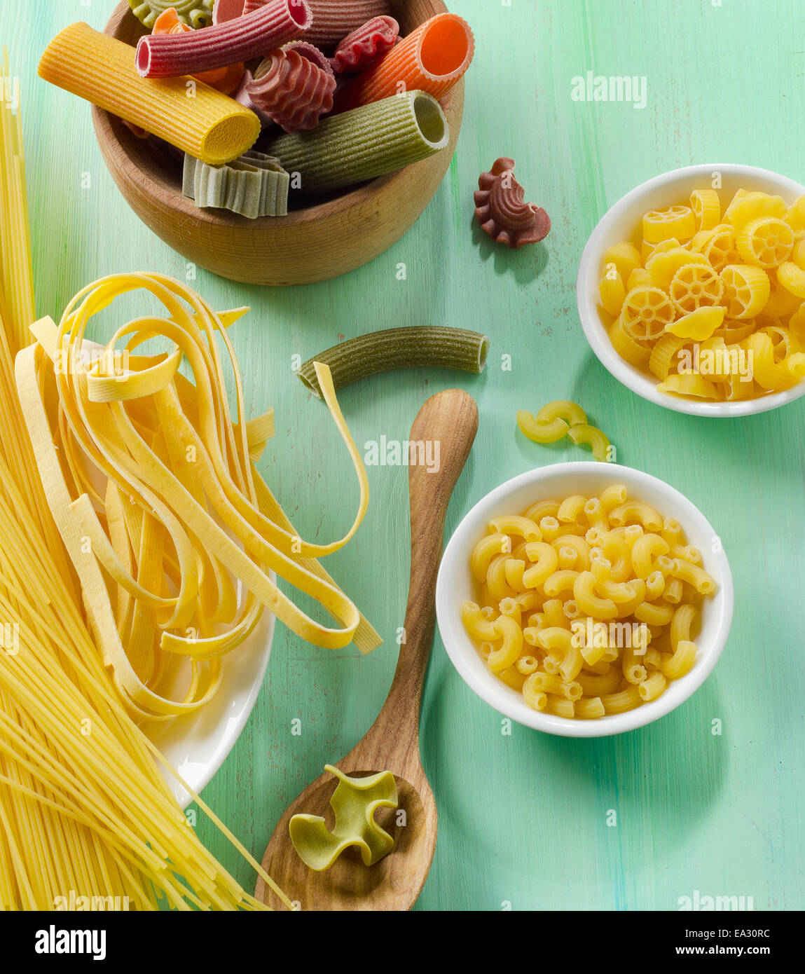 Different types of pasta on a wooden table Stock Photo - Alamy