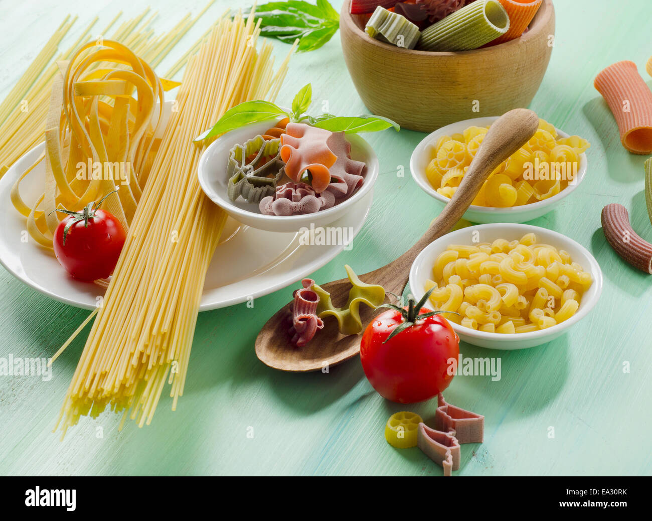 Different types of pasta on a wooden table Stock Photo - Alamy