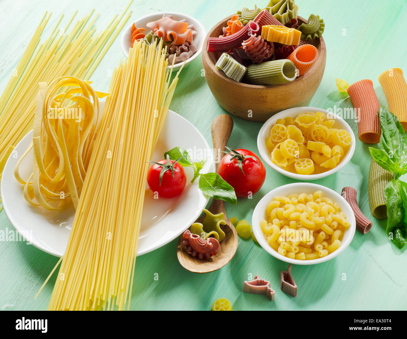 Different types of pasta on a wooden table Stock Photo - Alamy