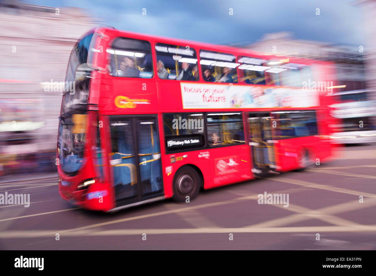 Motion blurred red double decker bus, Piccadilly Circus, London ...