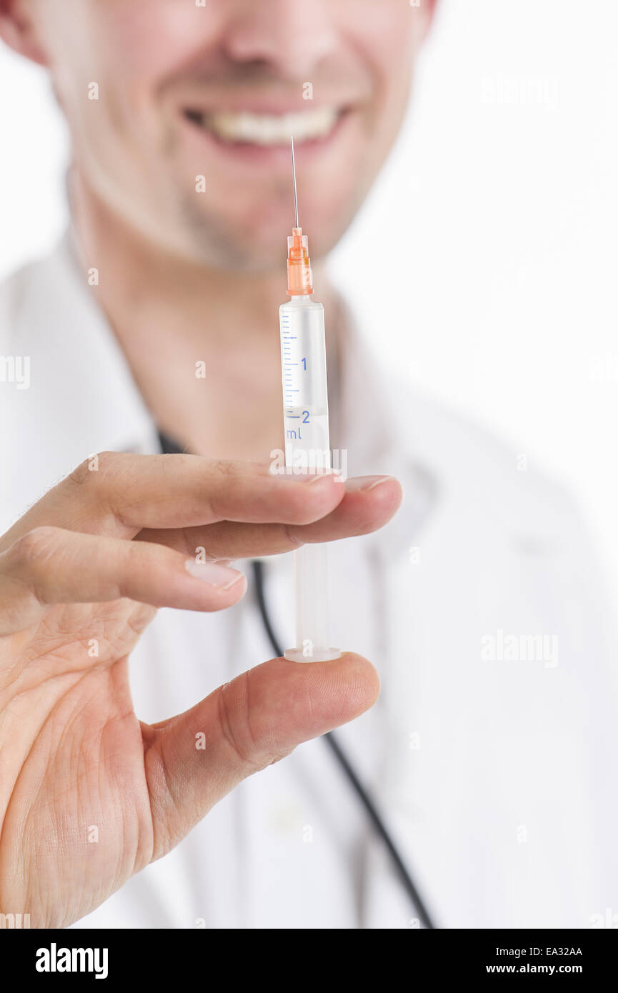Doctor with syringe in hand Stock Photo - Alamy