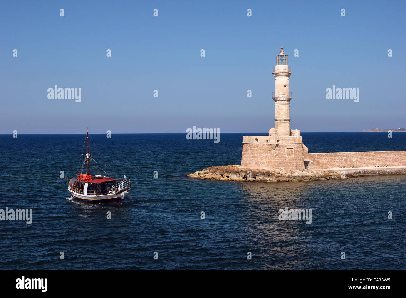 Lighthouse and a boat Stock Photo - Alamy