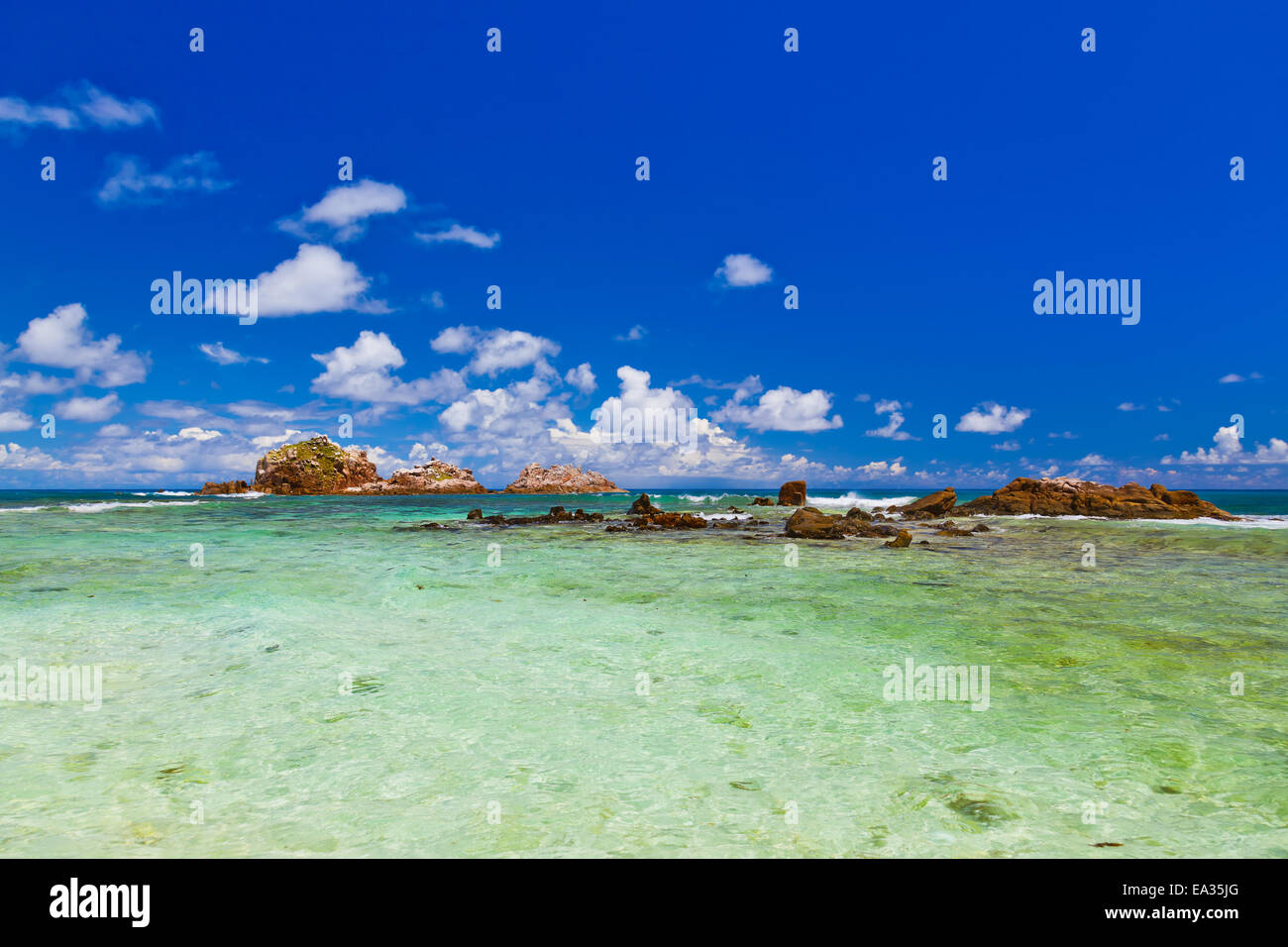 Stones in ocean at Seychelles Stock Photo - Alamy