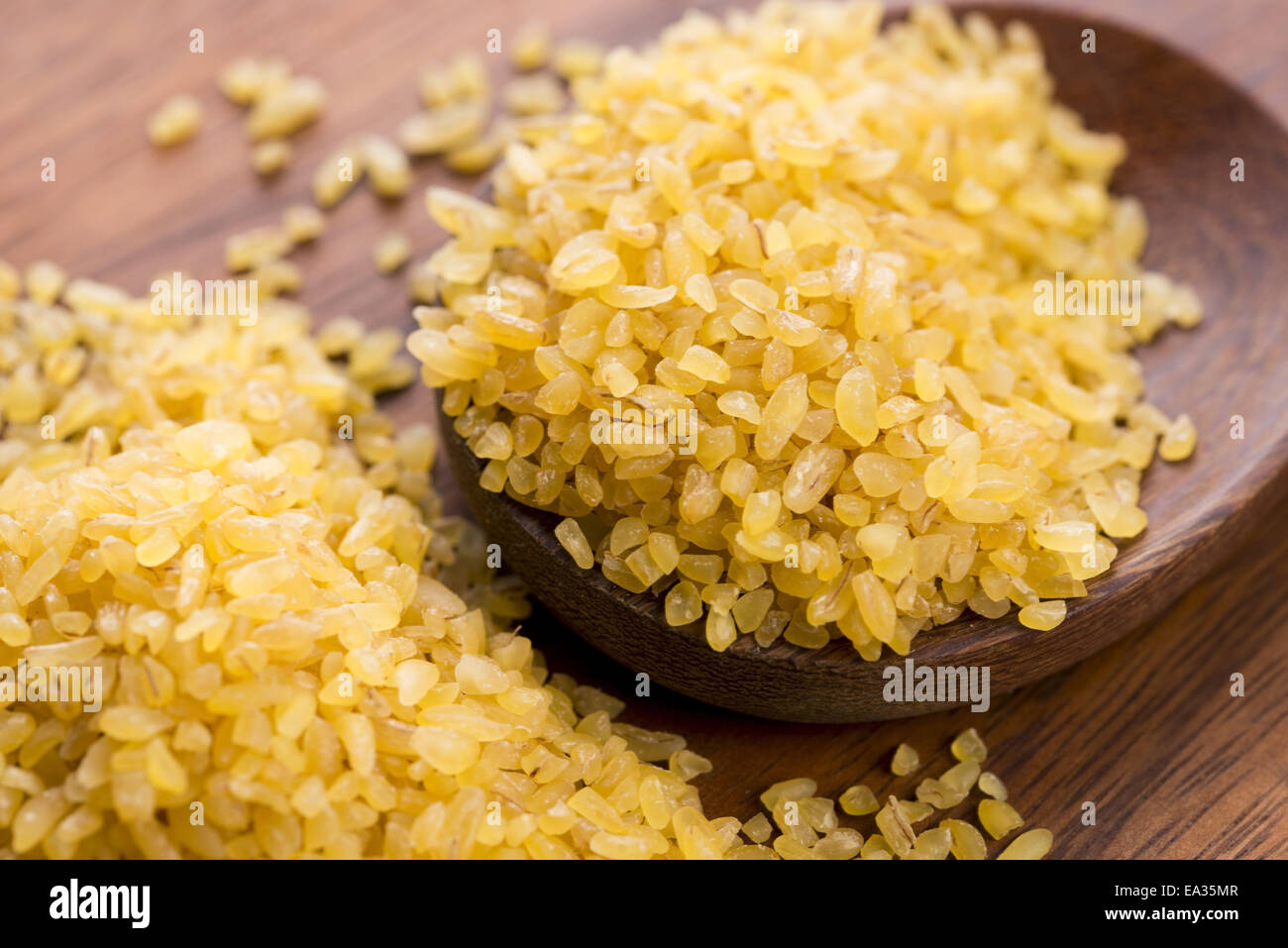 bulgur wheat in wooden spoon Stock Photo - Alamy