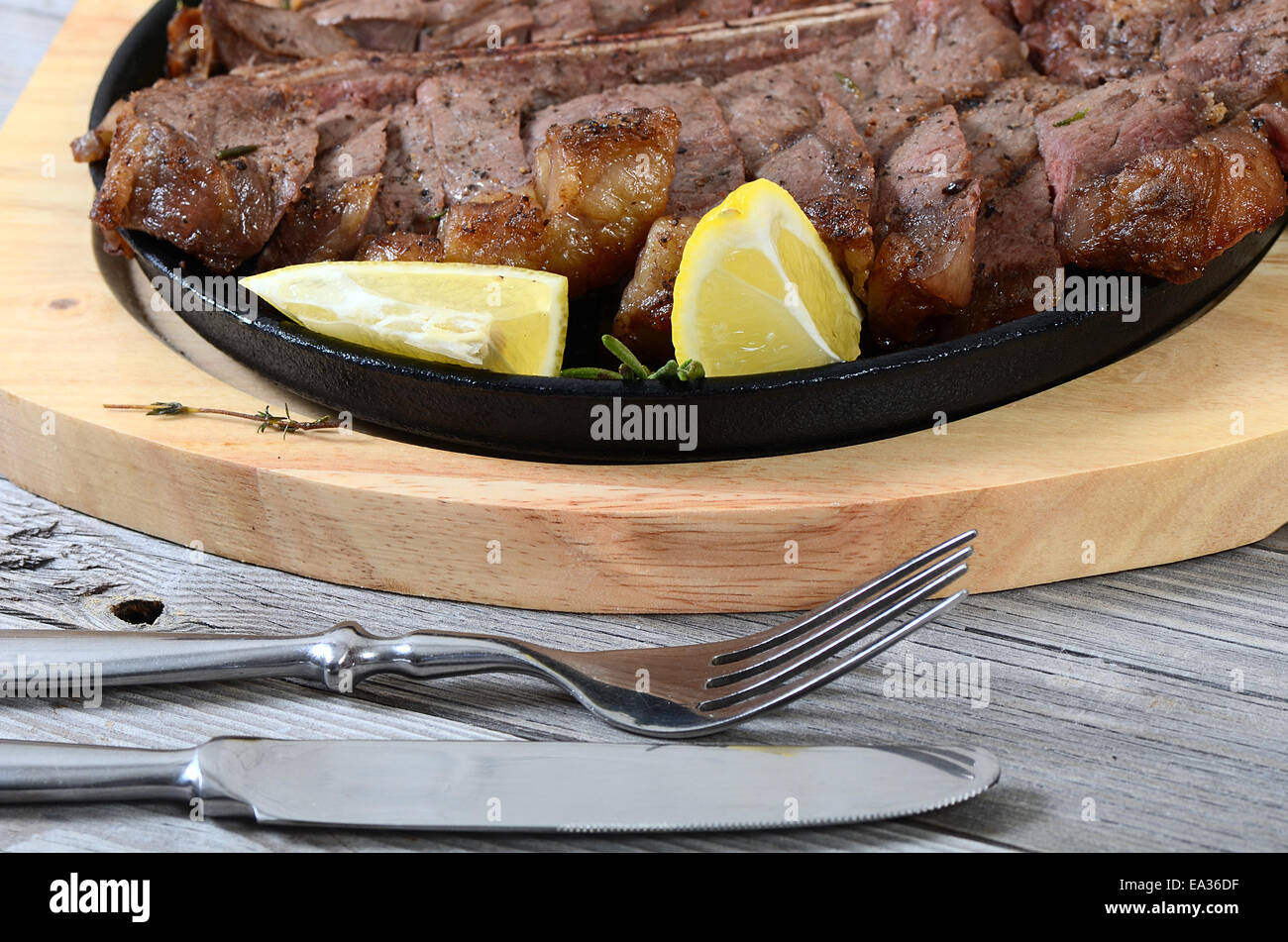 Stake from mutton with a lemon Stock Photo - Alamy