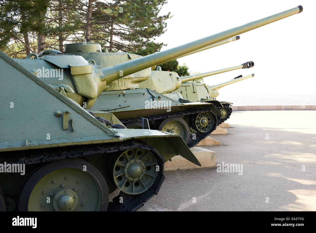 Row of old soviet tanks from the second world war isolated on white ...