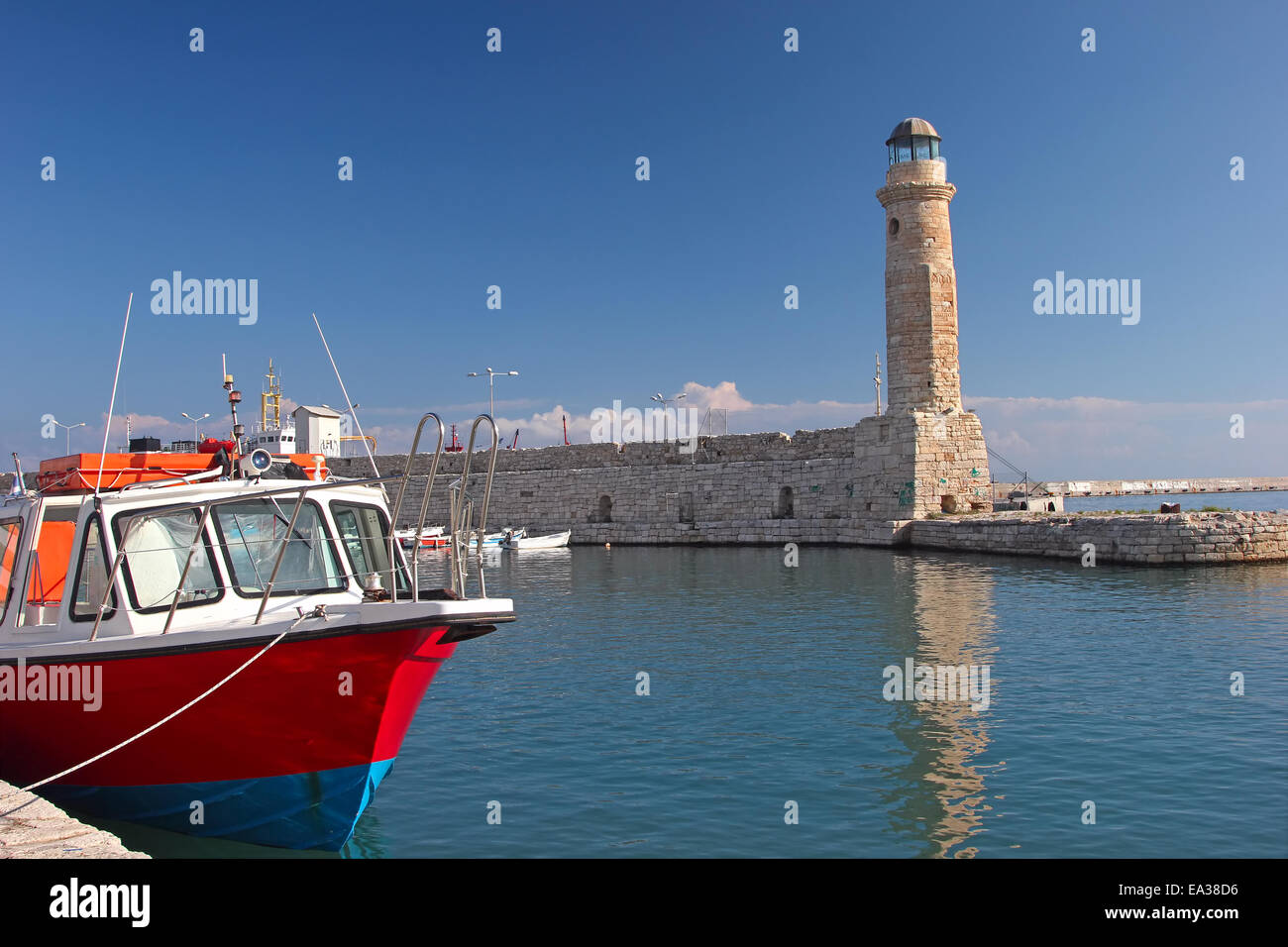 Lighthouse and a boat Stock Photo - Alamy