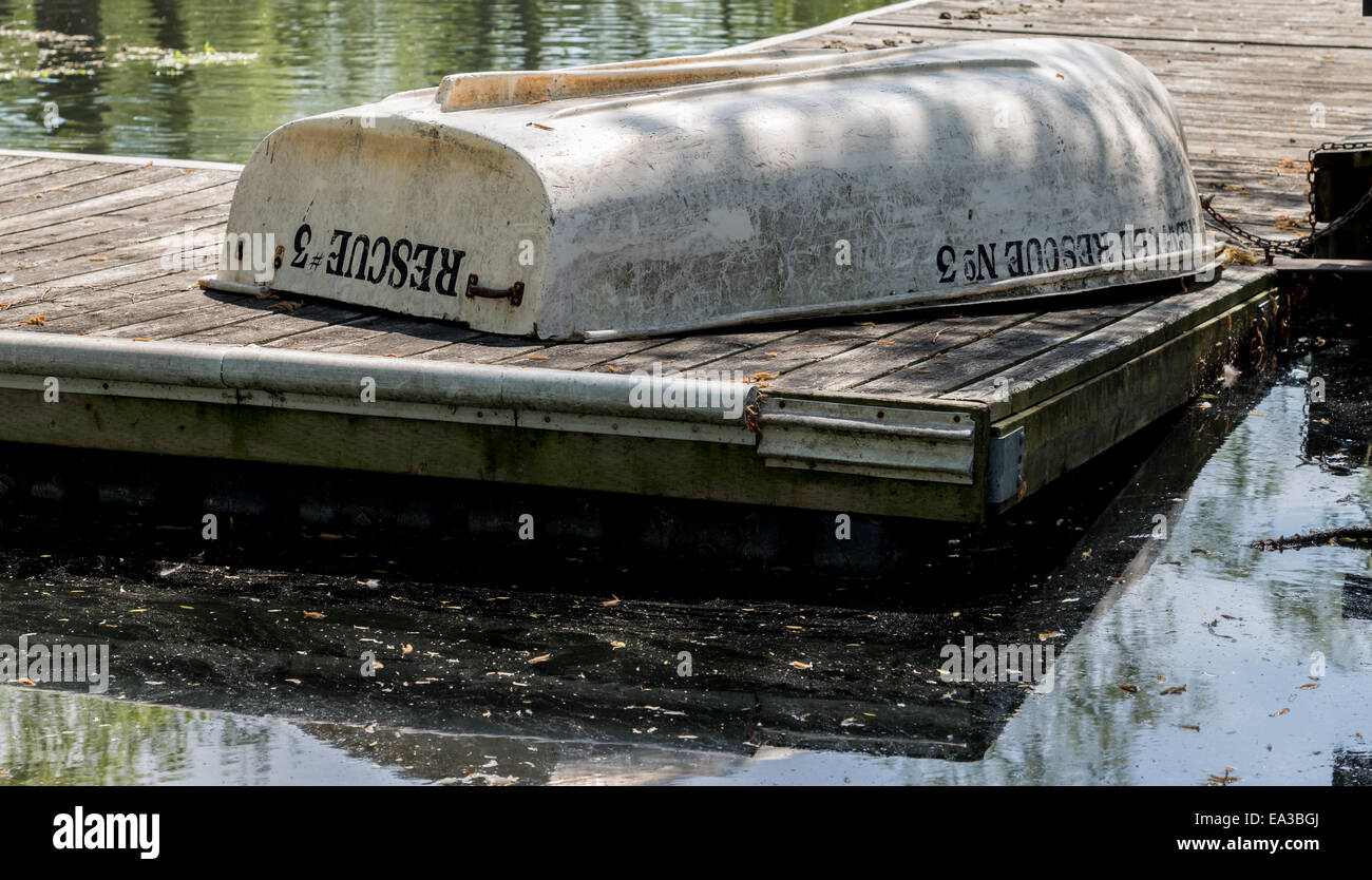 A over turned rescue boat on a wood dock Stock Photo - Alamy