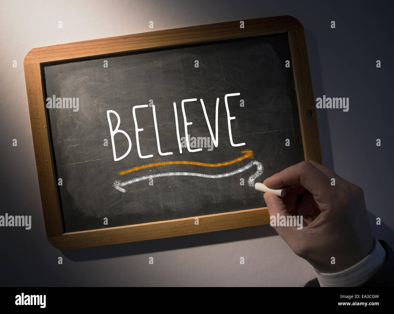 Hand writing Believe on chalkboard Stock Photo - Alamy