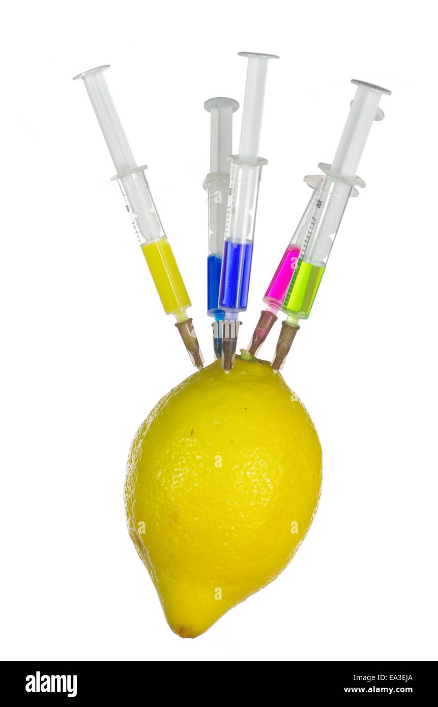 Injection into fresh lemon on white background Stock Photo - Alamy