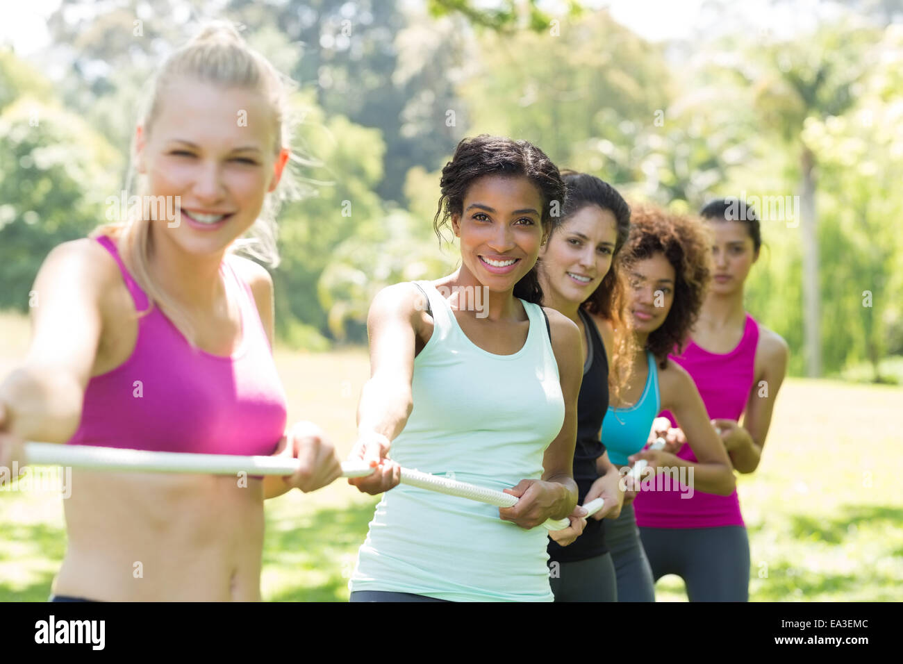 Women pulling a rope in tug of war Stock Photo - Alamy