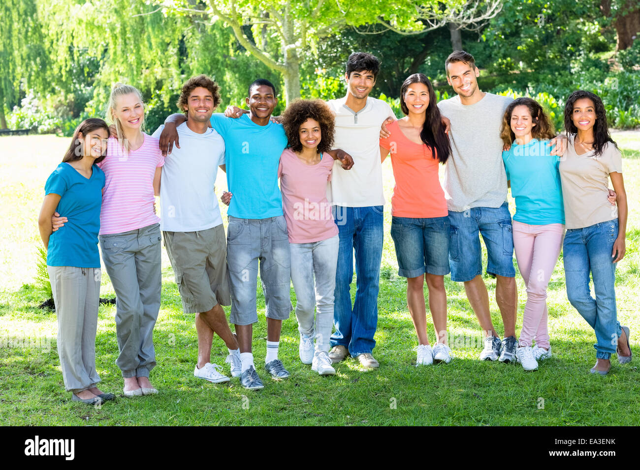 Friends standing with arms around Stock Photo - Alamy