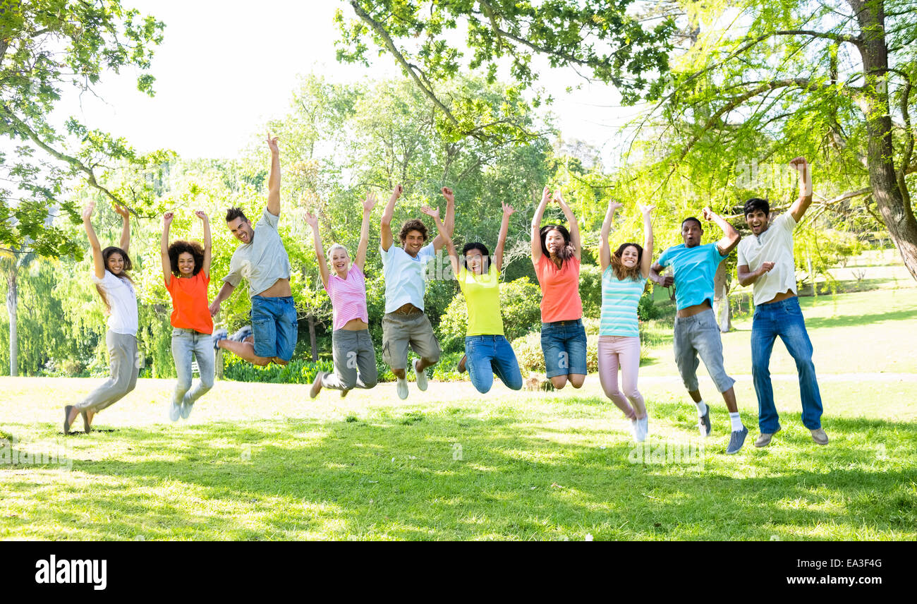 Friends jumping in park Stock Photo - Alamy