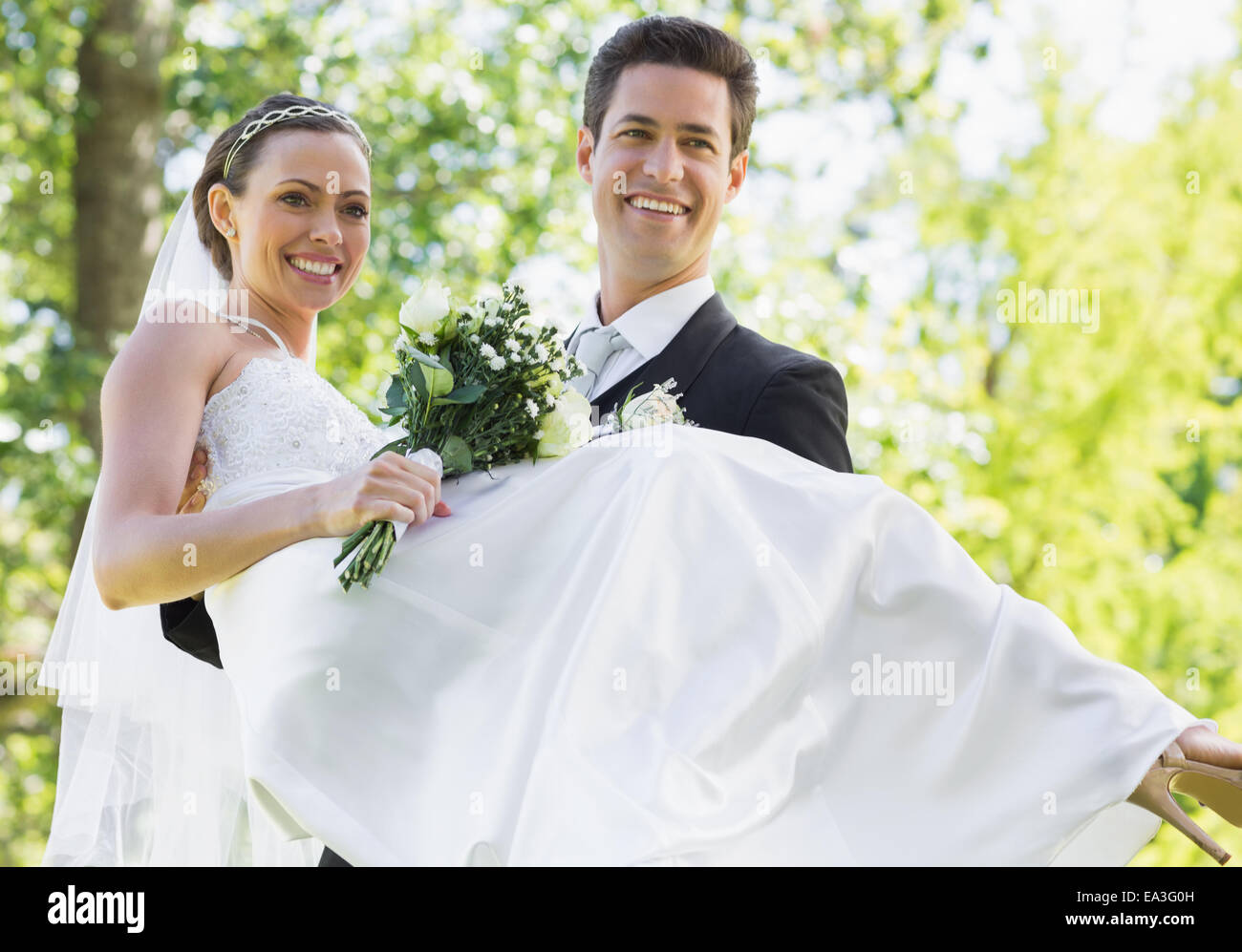 Bride carrying the groom hi-res stock photography and images - Alamy