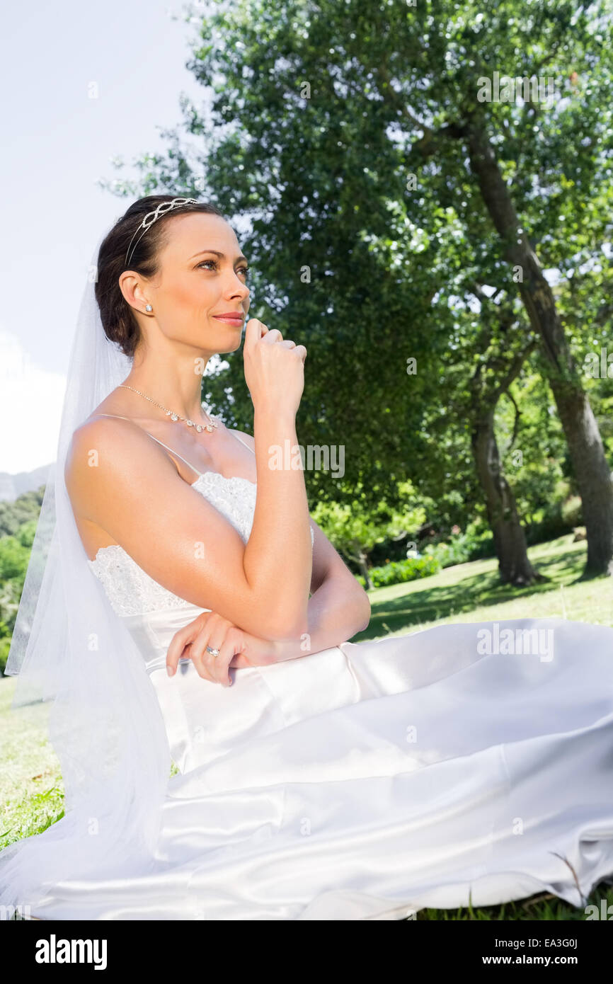 Young bride sitting in garden Stock Photo - Alamy