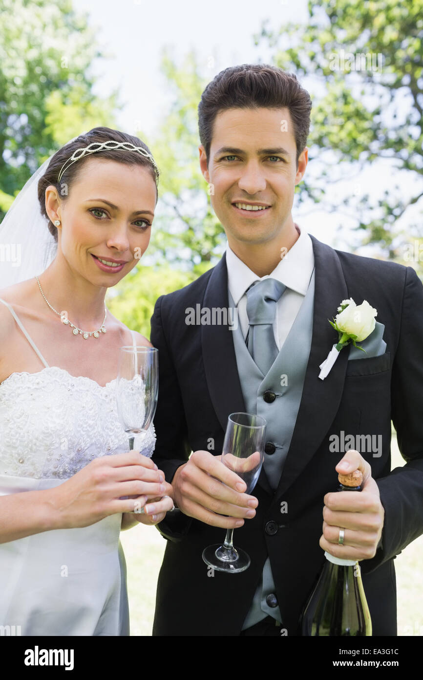 Newlywed couple having champagne Stock Photo - Alamy