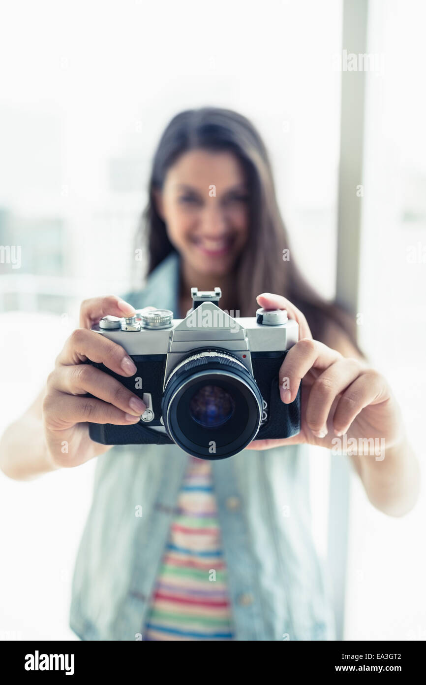 Happy young woman taking a photo at camera Stock Photo - Alamy