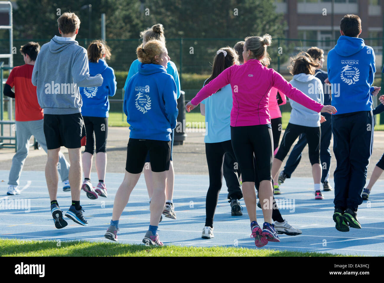 University sport, athletics training group warming up Stock Photo - Alamy