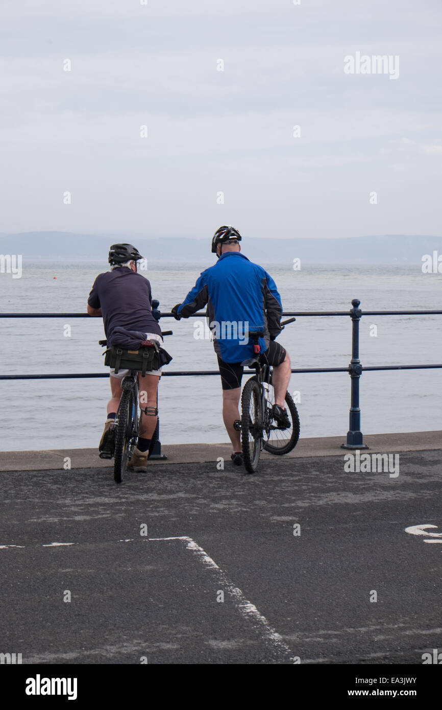 Two cyclists at seaside Stock Photo - Alamy
