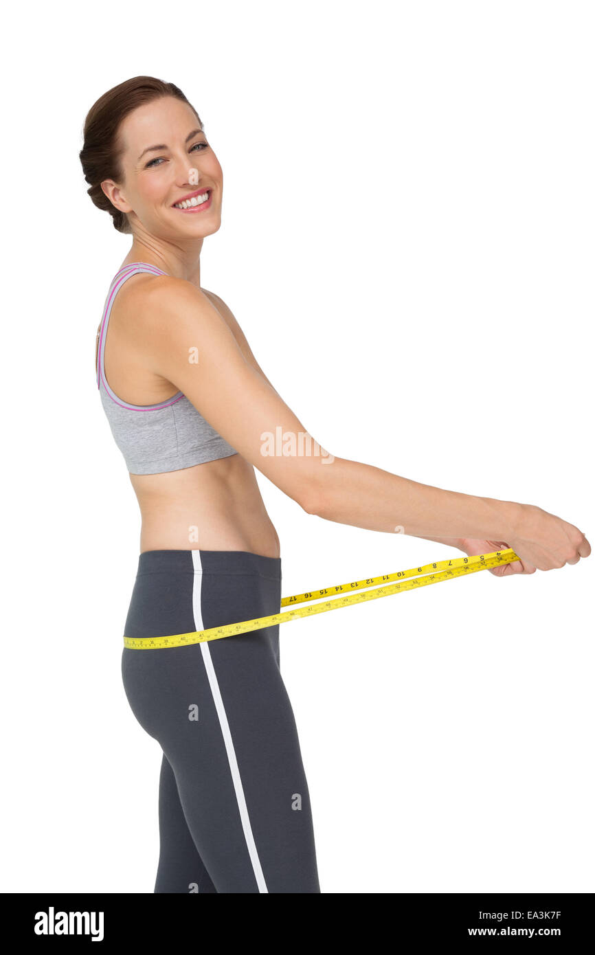 Portrait of a fit woman measuring buttocks Stock Photo - Alamy