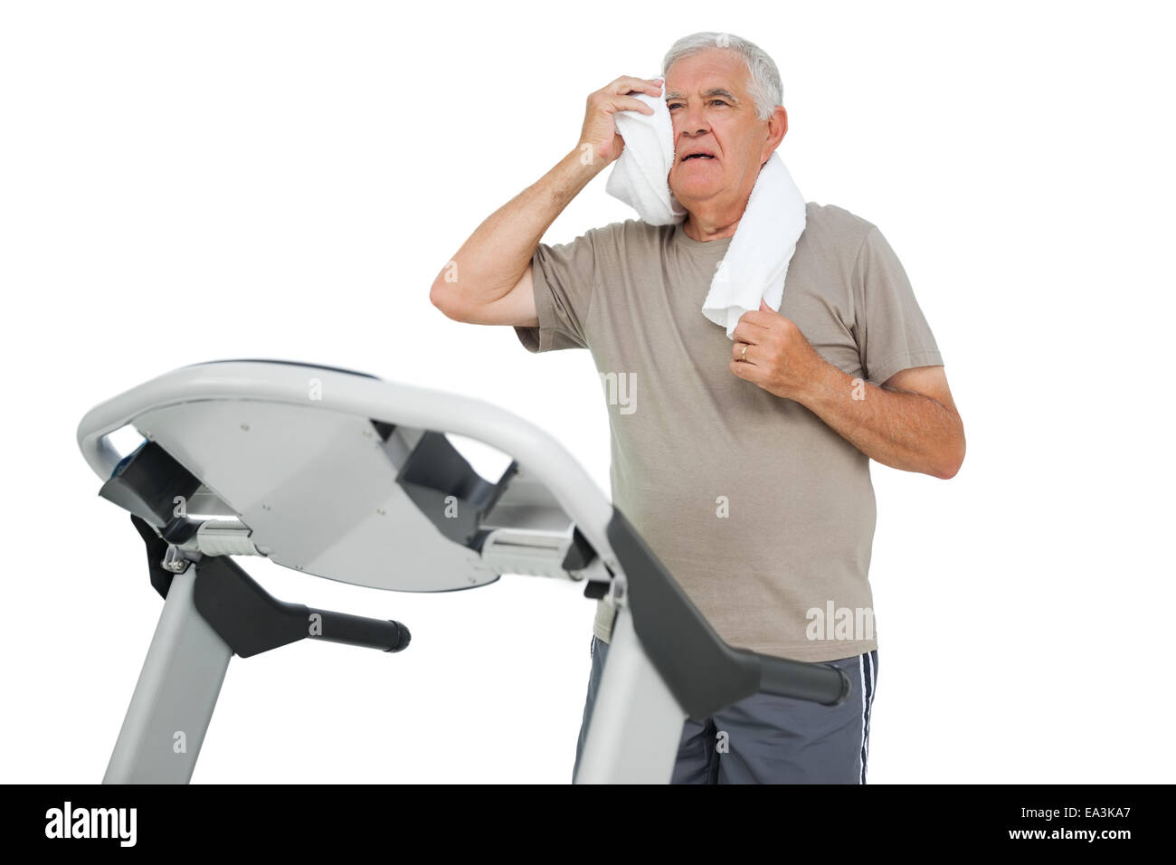 Tired senior man running on a treadmill Stock Photo - Alamy