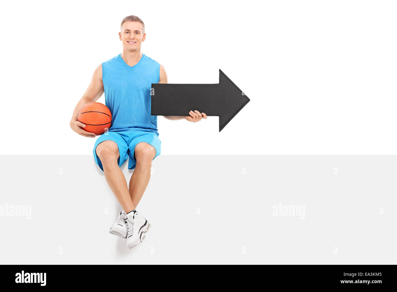 Basketball player holding an arrow seated on panel isolated on white ...