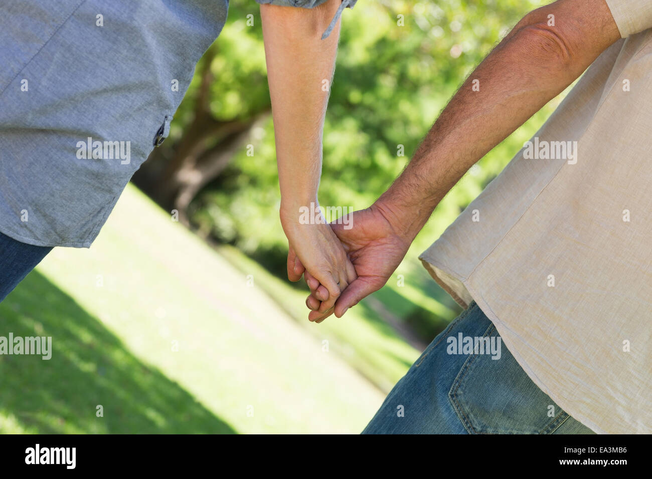 Romantic couple holding hands Stock Photo - Alamy