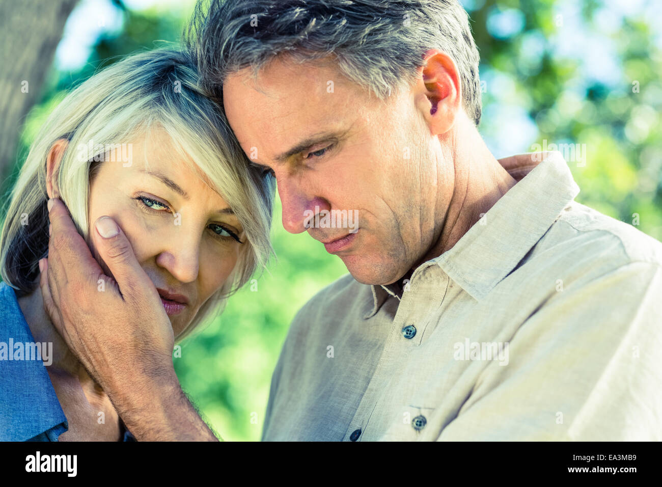 Loving man comforting woman Stock Photo - Alamy