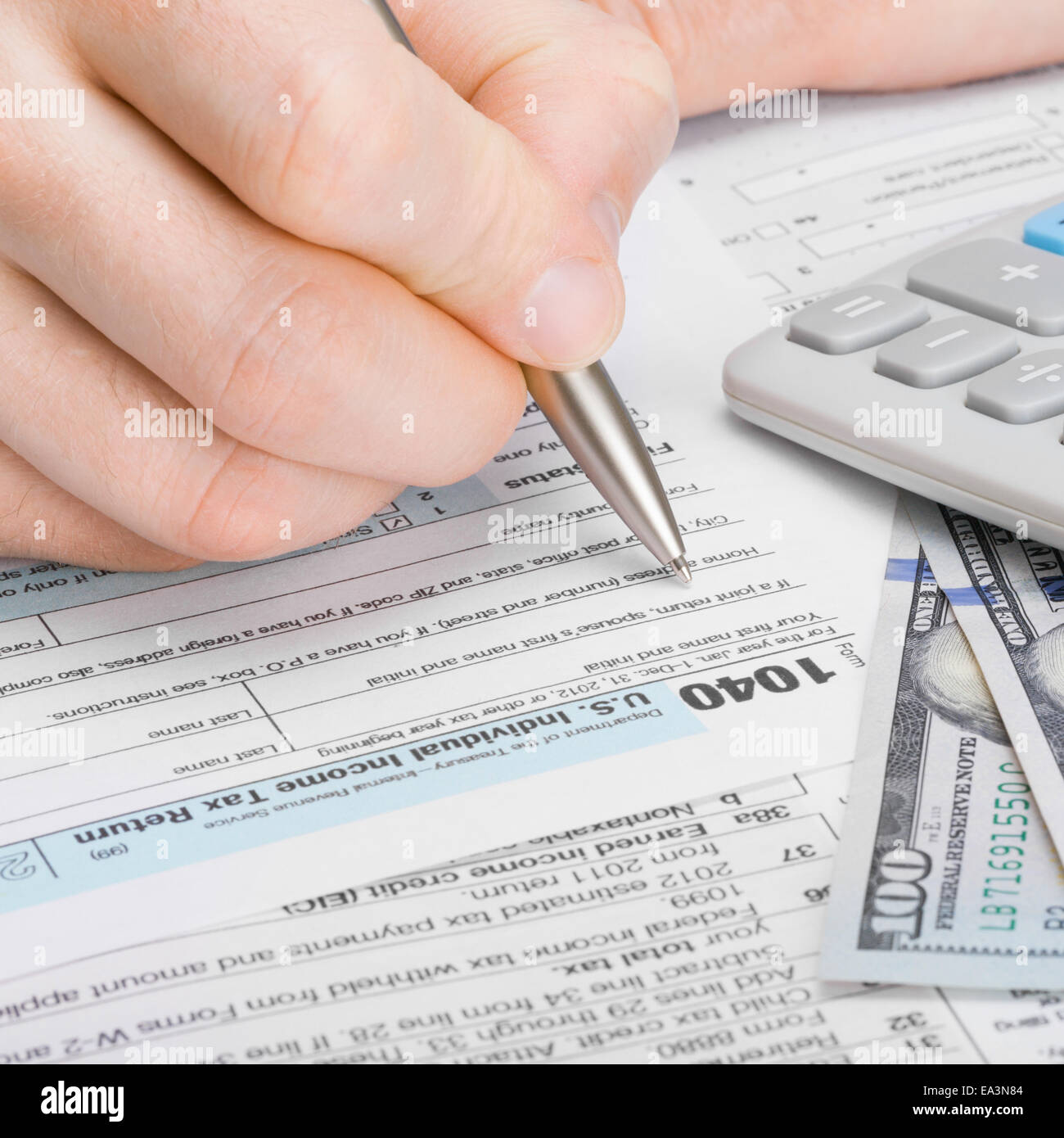 Male filling out 1040 Tax Form Stock Photo - Alamy
