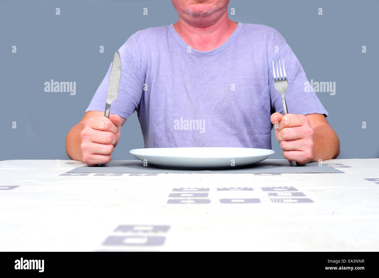 Man waiting at a table waiting to eat alone Stock Photo - Alamy