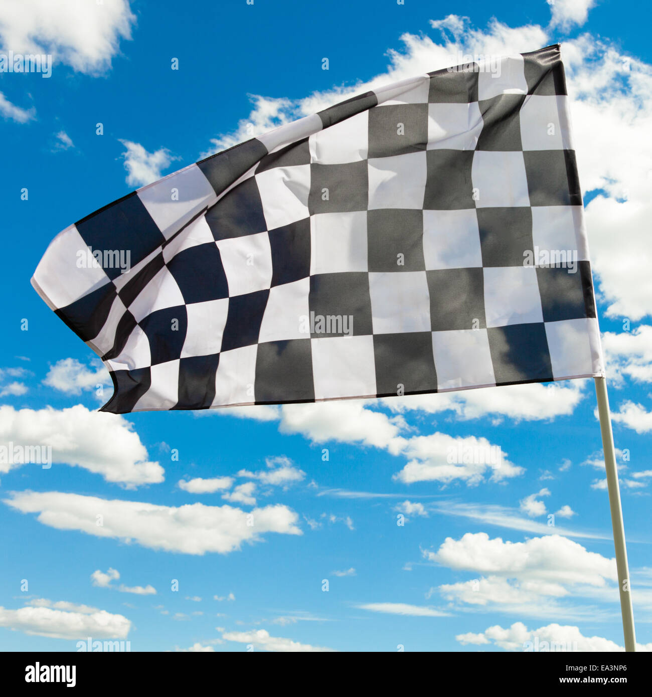 Checkered flag against the blue sky with clouds Stock Photo - Alamy