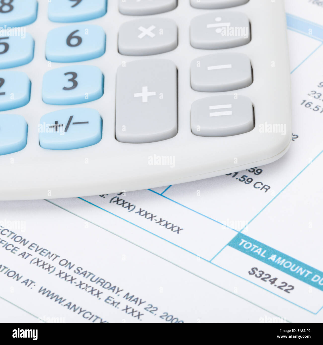 Neat calculator over utility bill - studio shot Stock Photo - Alamy