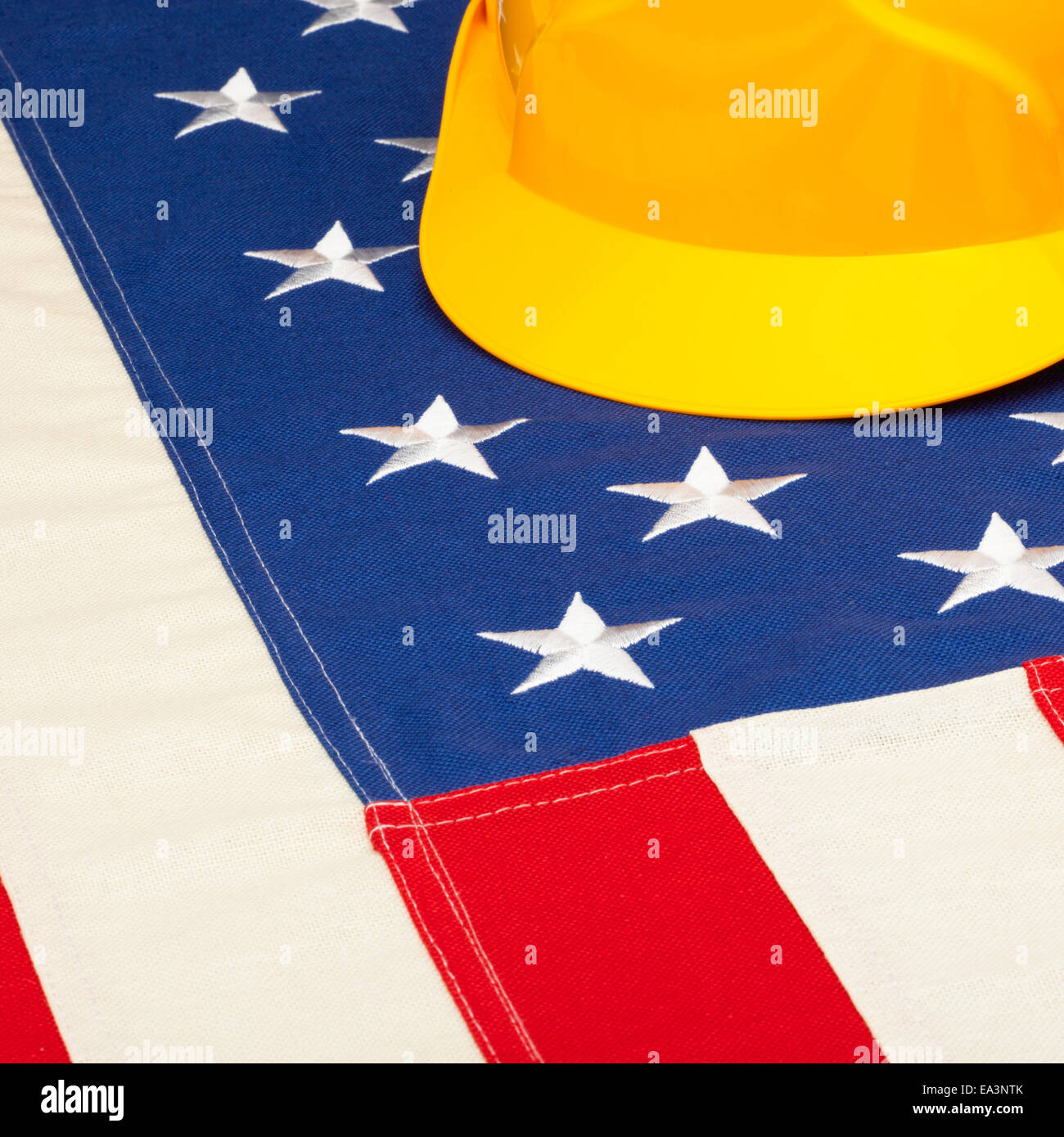 Construction helmet over US flag - closeup shoot Stock Photo - Alamy