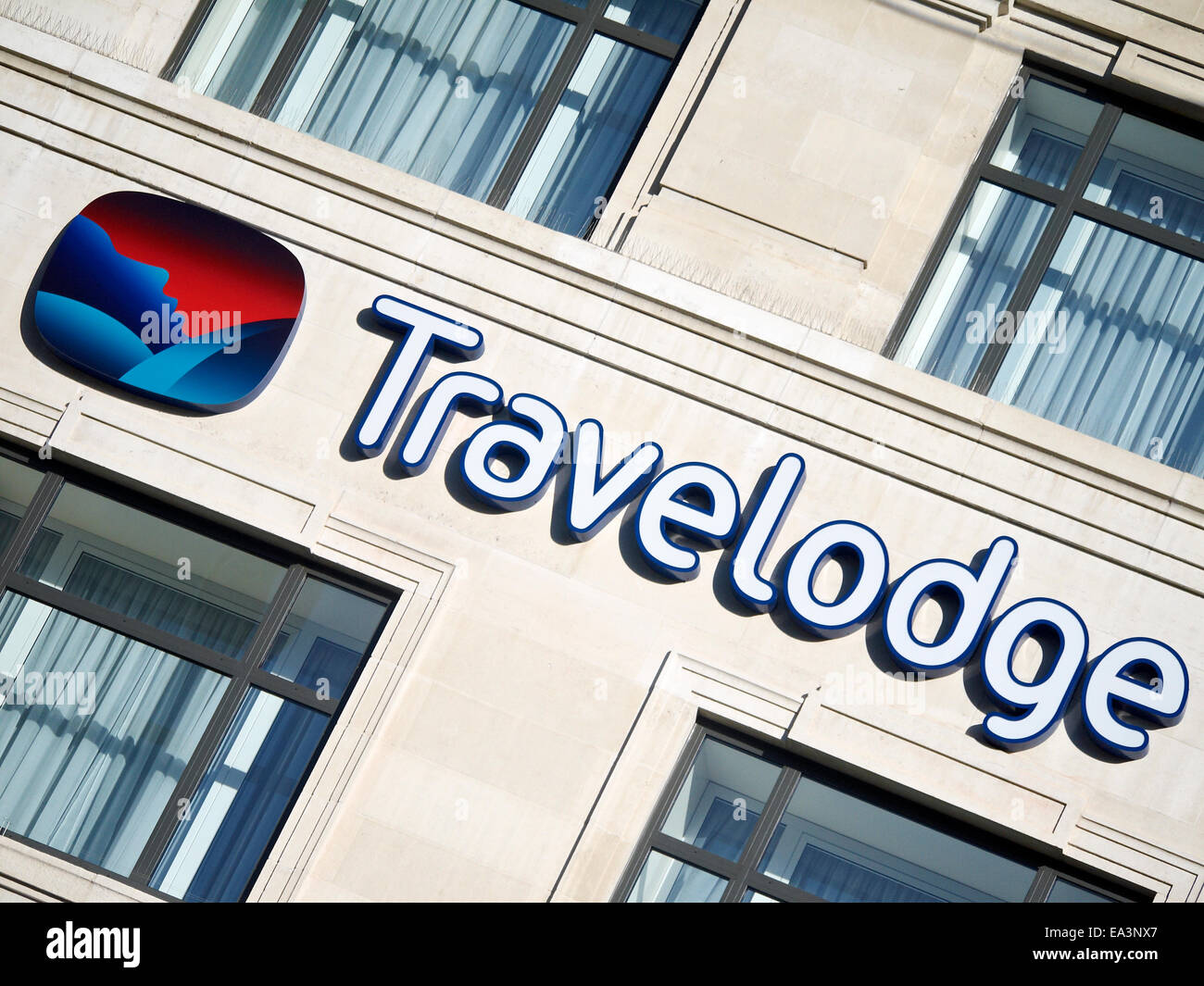 Travelodge hotel sign on outside wall in Manchester UK Stock Photo - Alamy