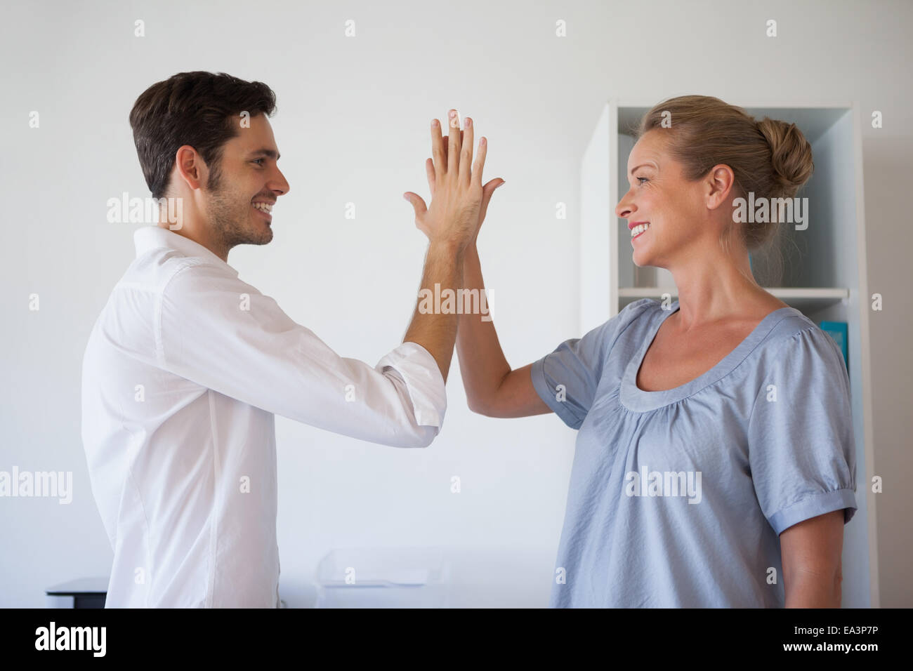 High fiving female coworkers hi-res stock photography and images - Alamy