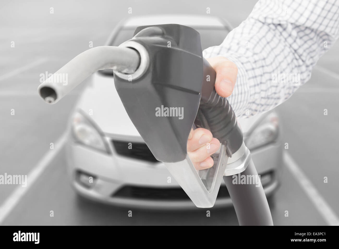 Black color fuel pump gun in hand with car on background Stock Photo ...