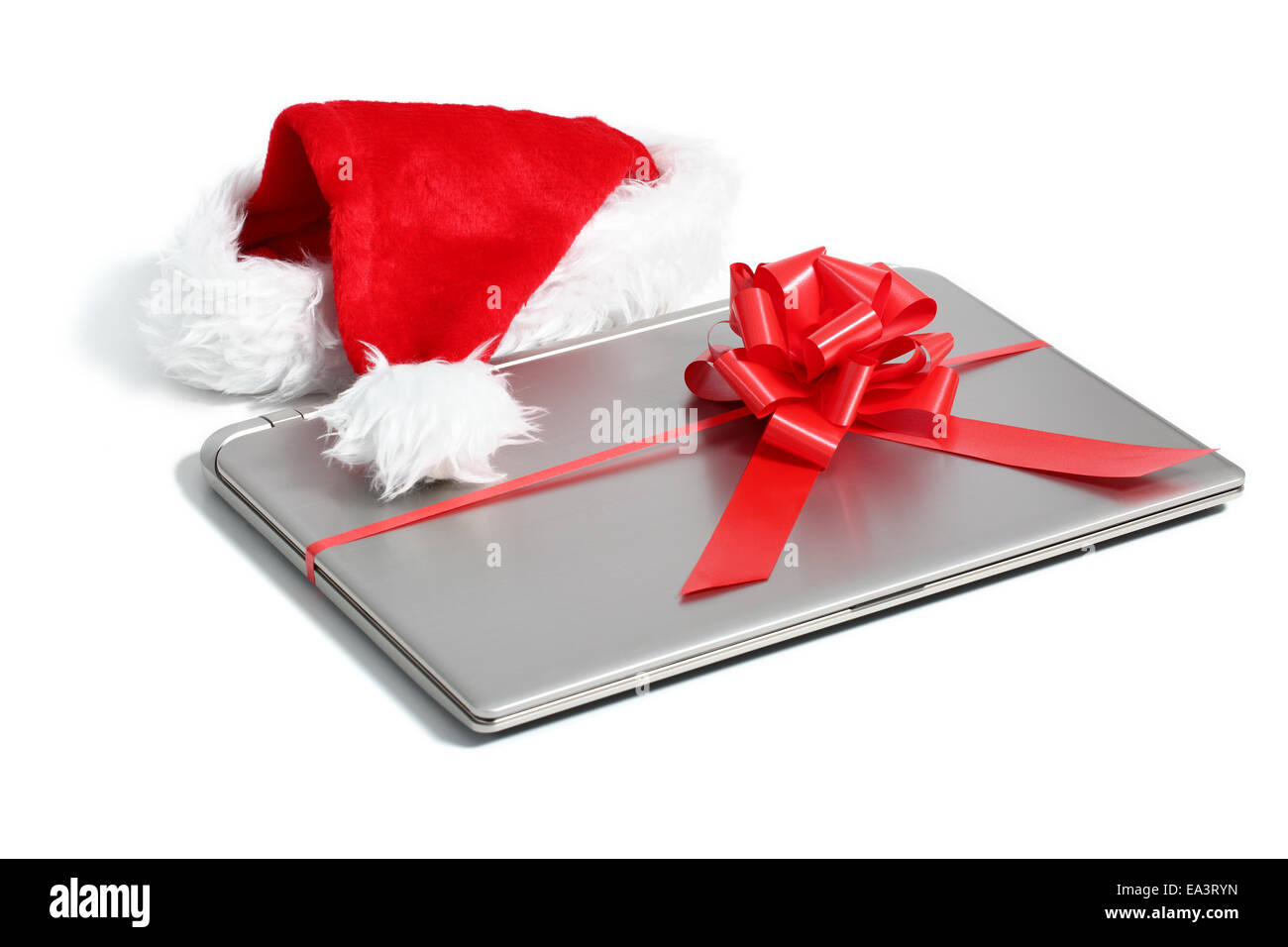 Laptop computer christmas gift with a ribbon isolated on a white ...