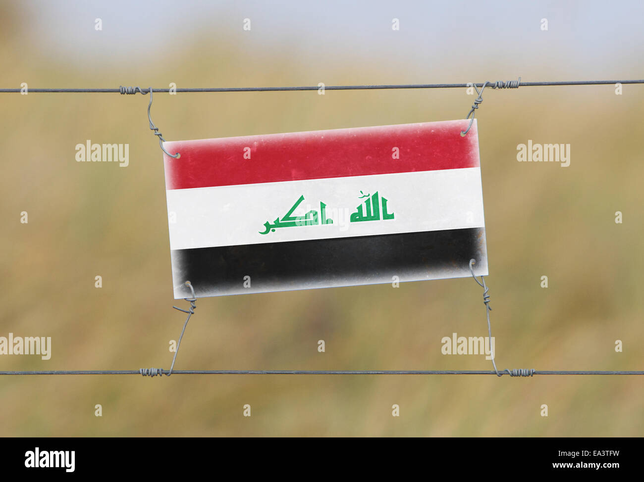 Border fence - Old plastic sign with a flag - Iraq Stock Photo - Alamy