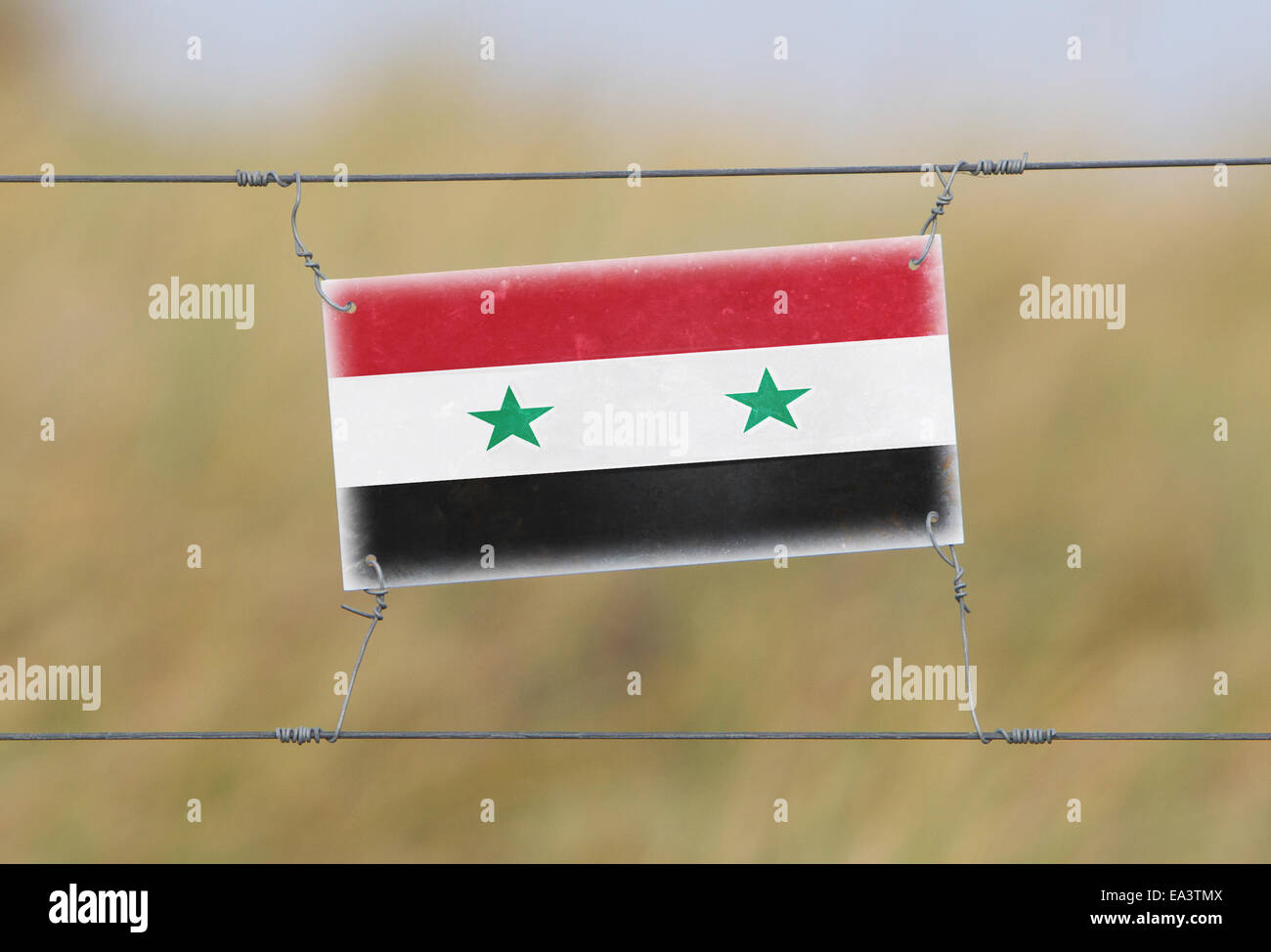 Border fence - Old plastic sign with a flag - Syria Stock Photo - Alamy