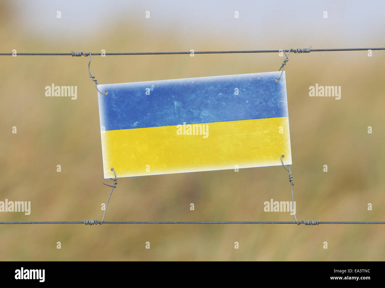 Border fence - Old plastic sign with a flag - Ukraine Stock Photo - Alamy