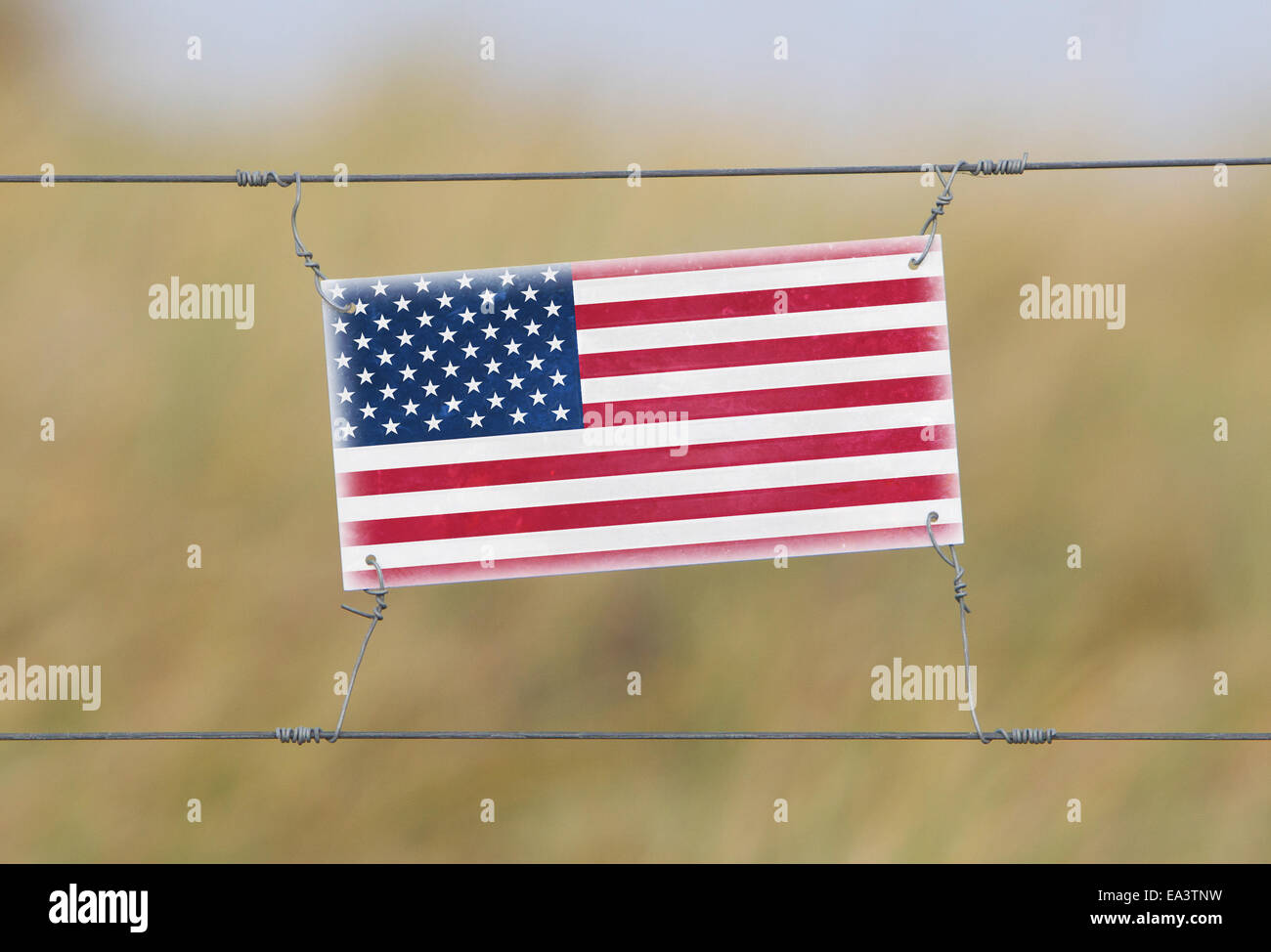 Border fence - Old plastic sign with a flag - USA Stock Photo - Alamy