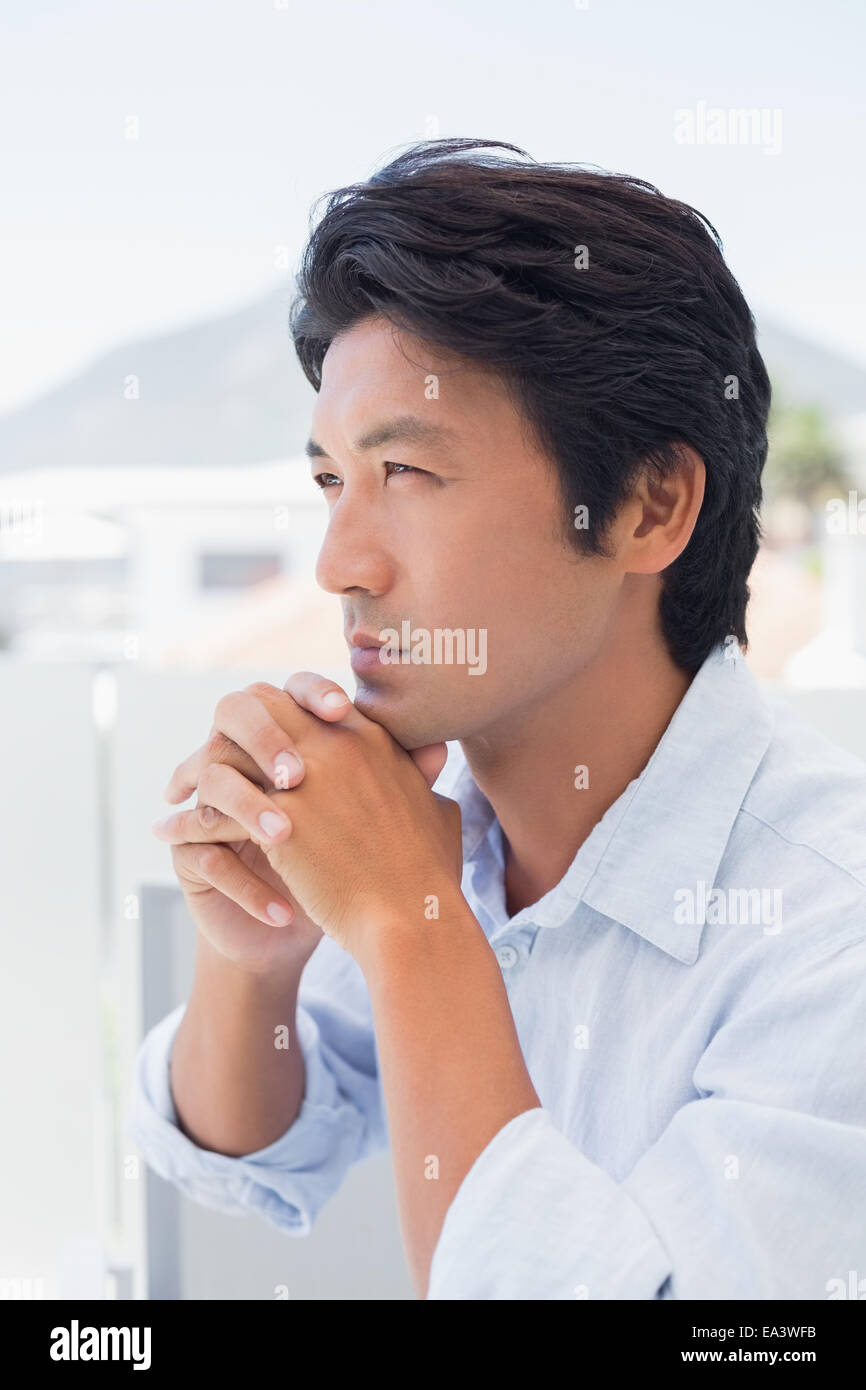 Thinking man with hands together Stock Photo - Alamy