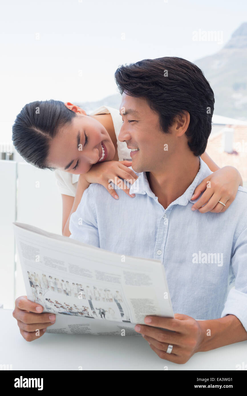 Couple reading a newspaper together Stock Photo - Alamy