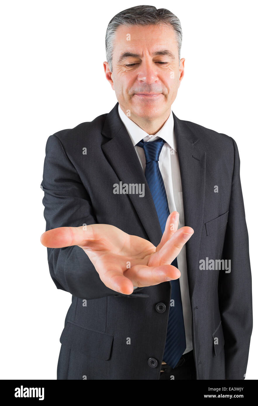 Mature businessman standing with hand out Stock Photo - Alamy