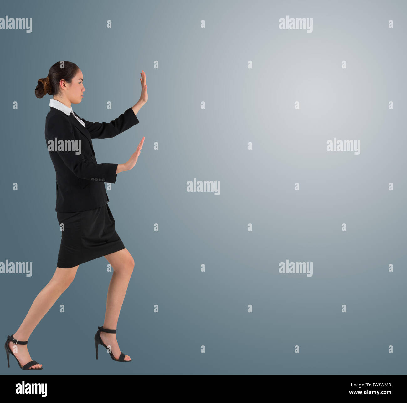 Businesswoman in suit standing and pushing Stock Photo - Alamy