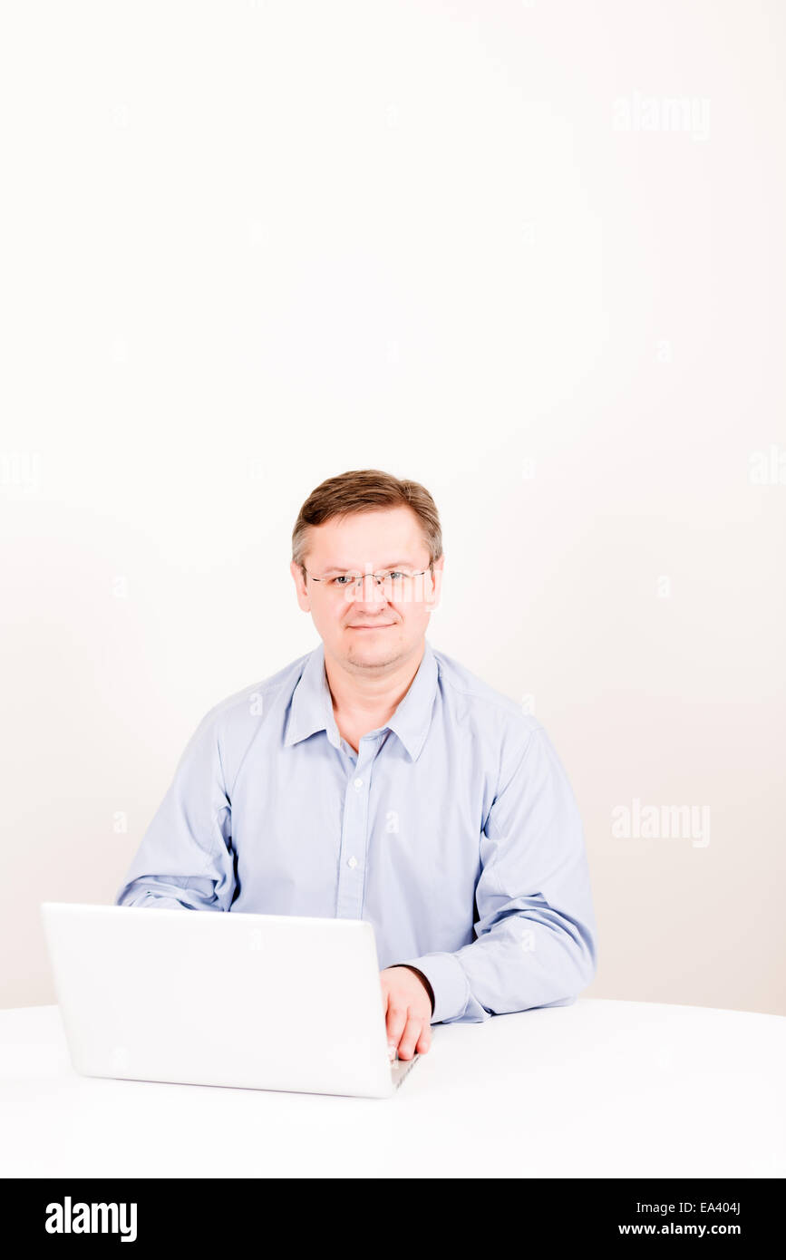 Middleaged man posing with laptop Stock Photo - Alamy