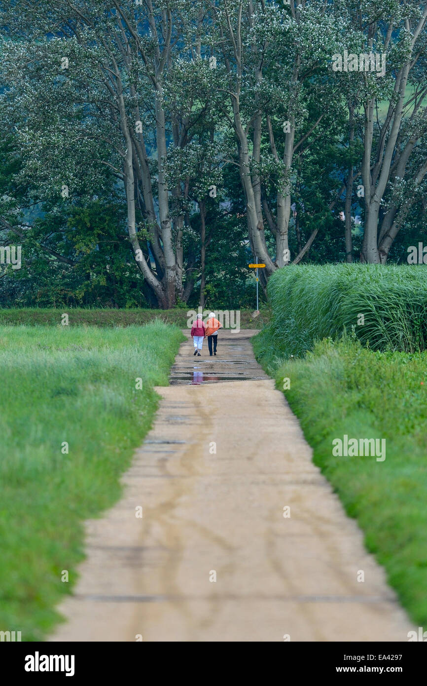 Two elderly ladies walking along a rural path Stock Photo - Alamy